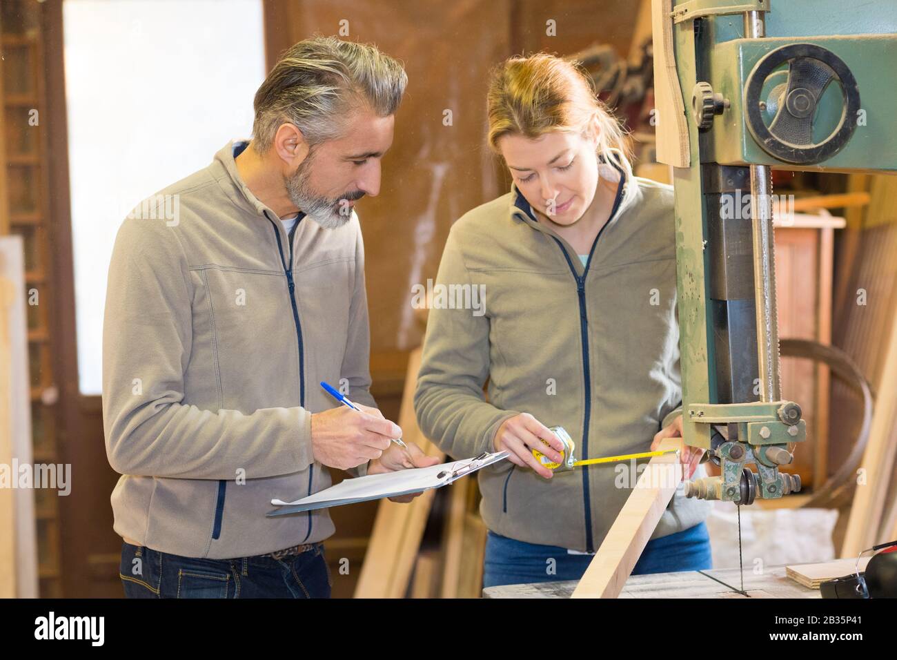 workers measuring width of wood in workshop Stock Photo - Alamy