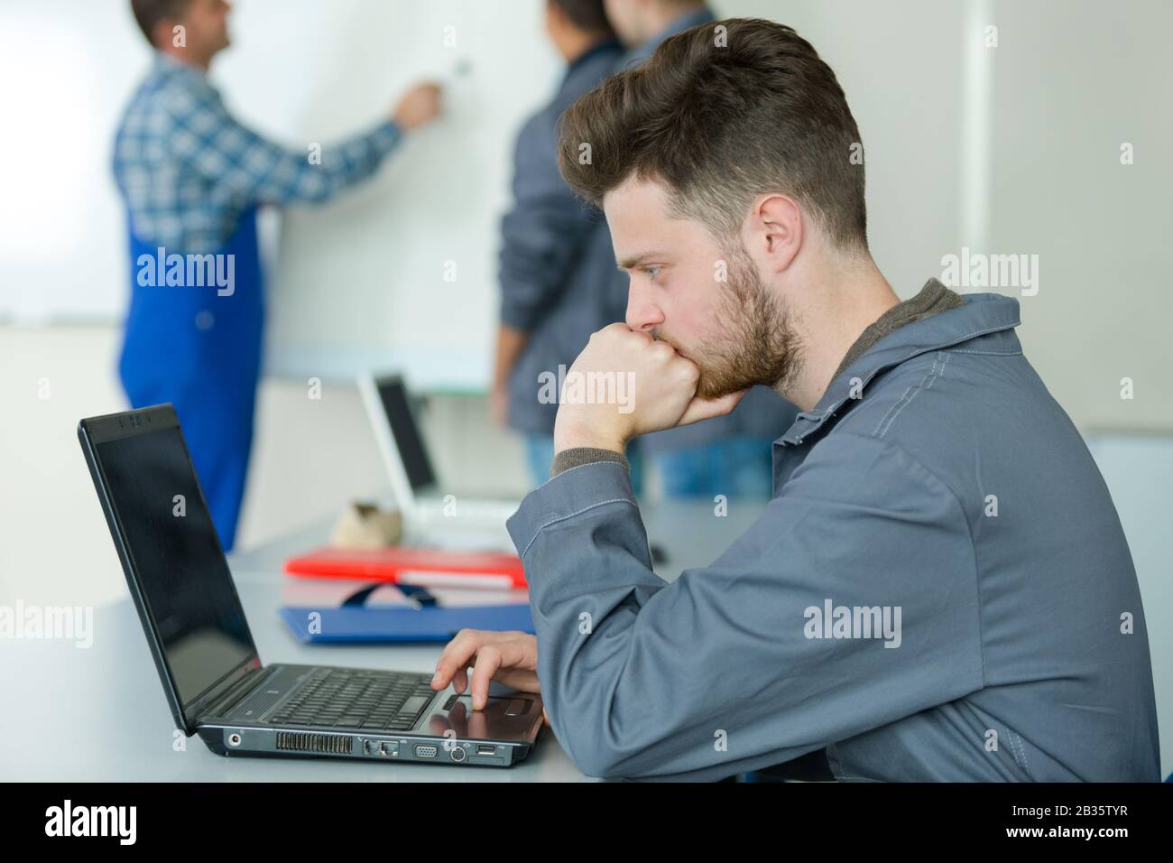 electrical engineer looking at computer during class Stock Photo - Alamy