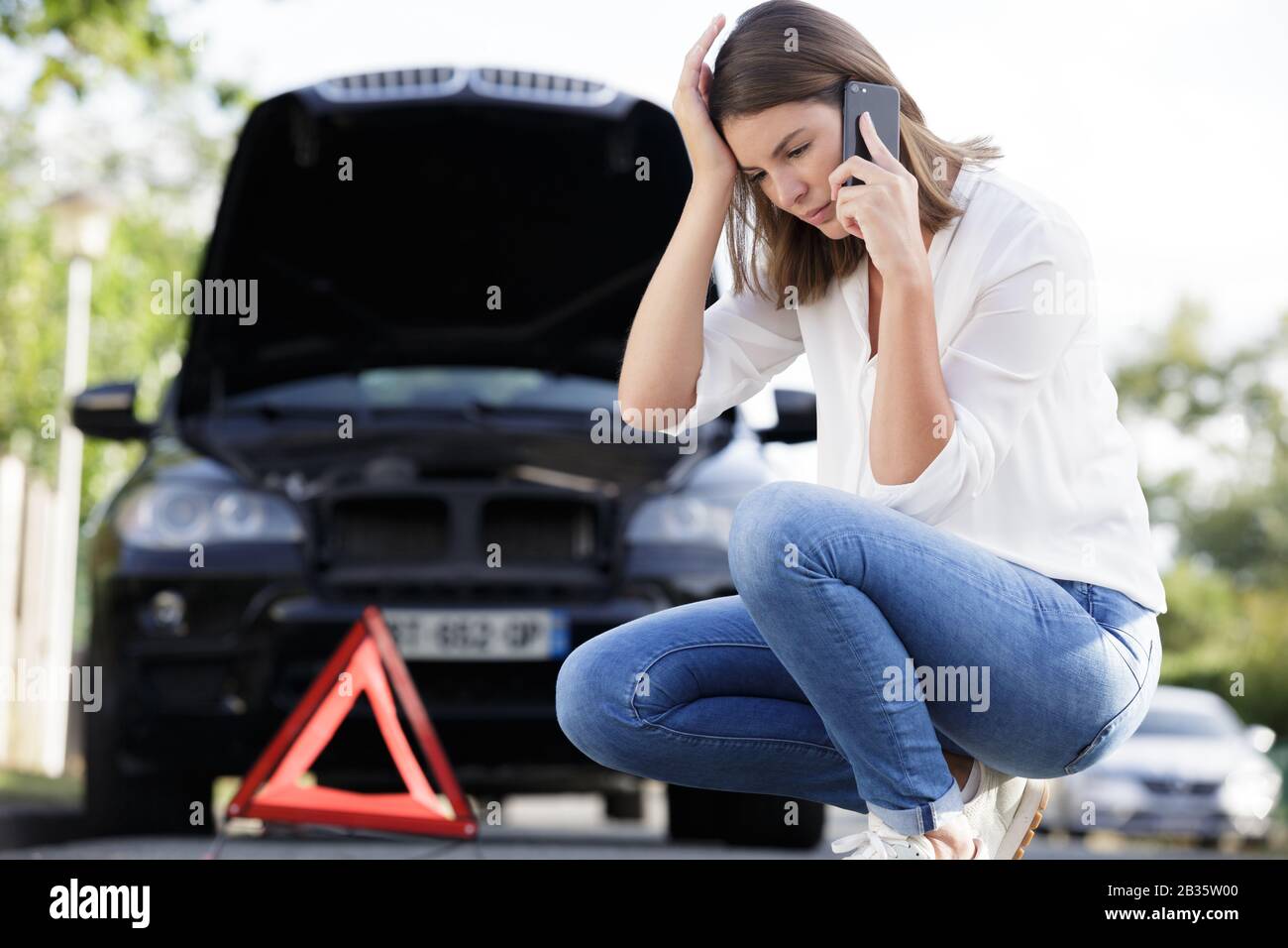 a woman calling road assistance Stock Photo - Alamy