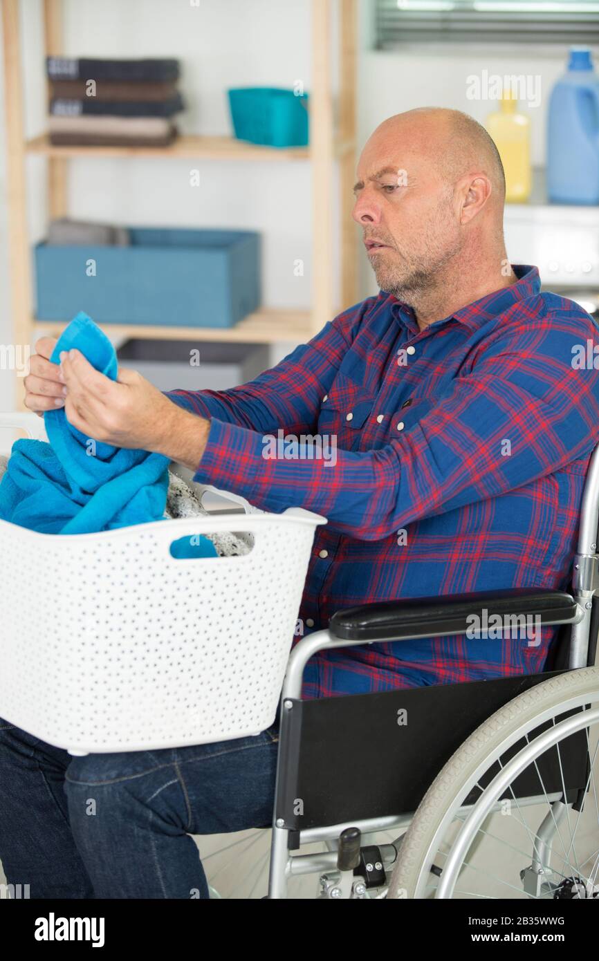 disabled man on wheelchair doing laundry Stock Photo - Alamy