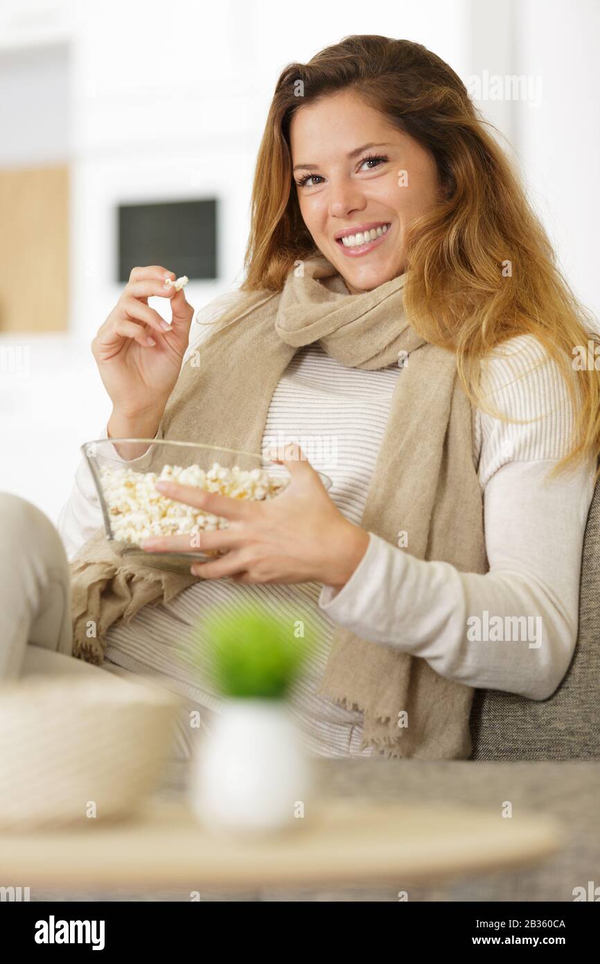 happy woman eating popcorn Stock Photo - Alamy