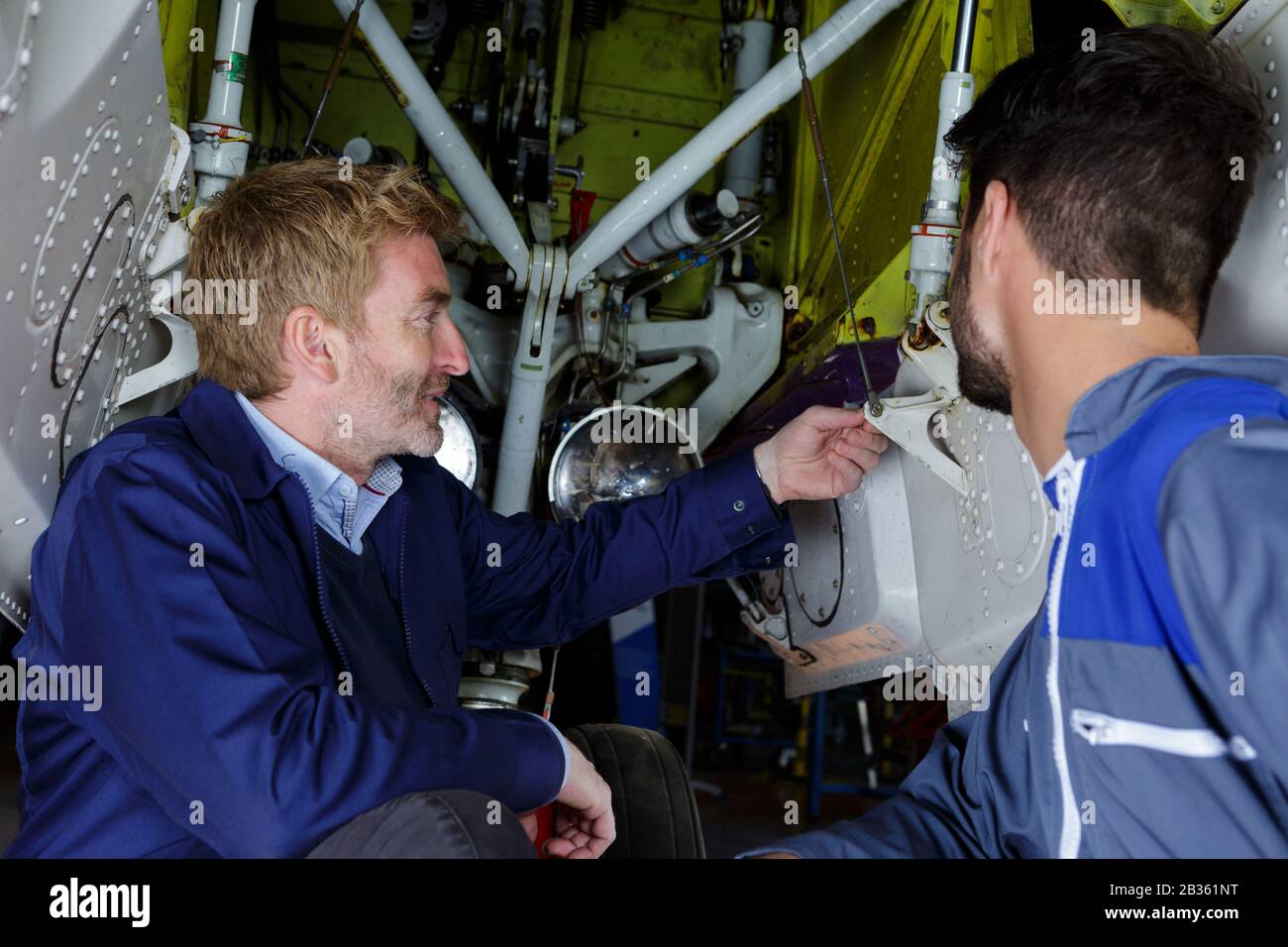 mechanic and male trainee working together Stock Photo - Alamy