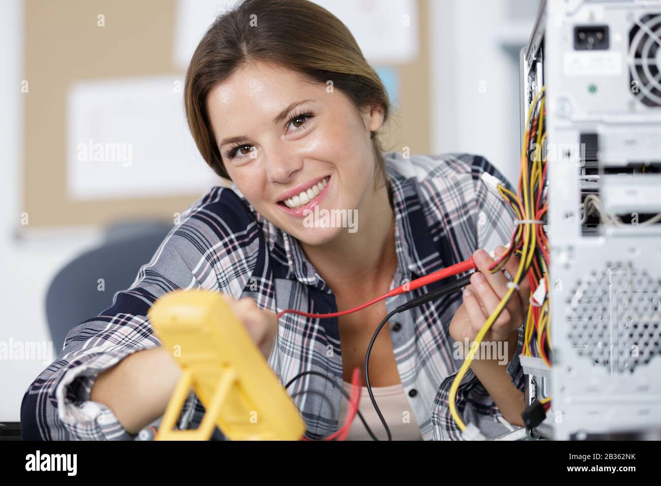 happy female technician repairing a computer Stock Photo - Alamy