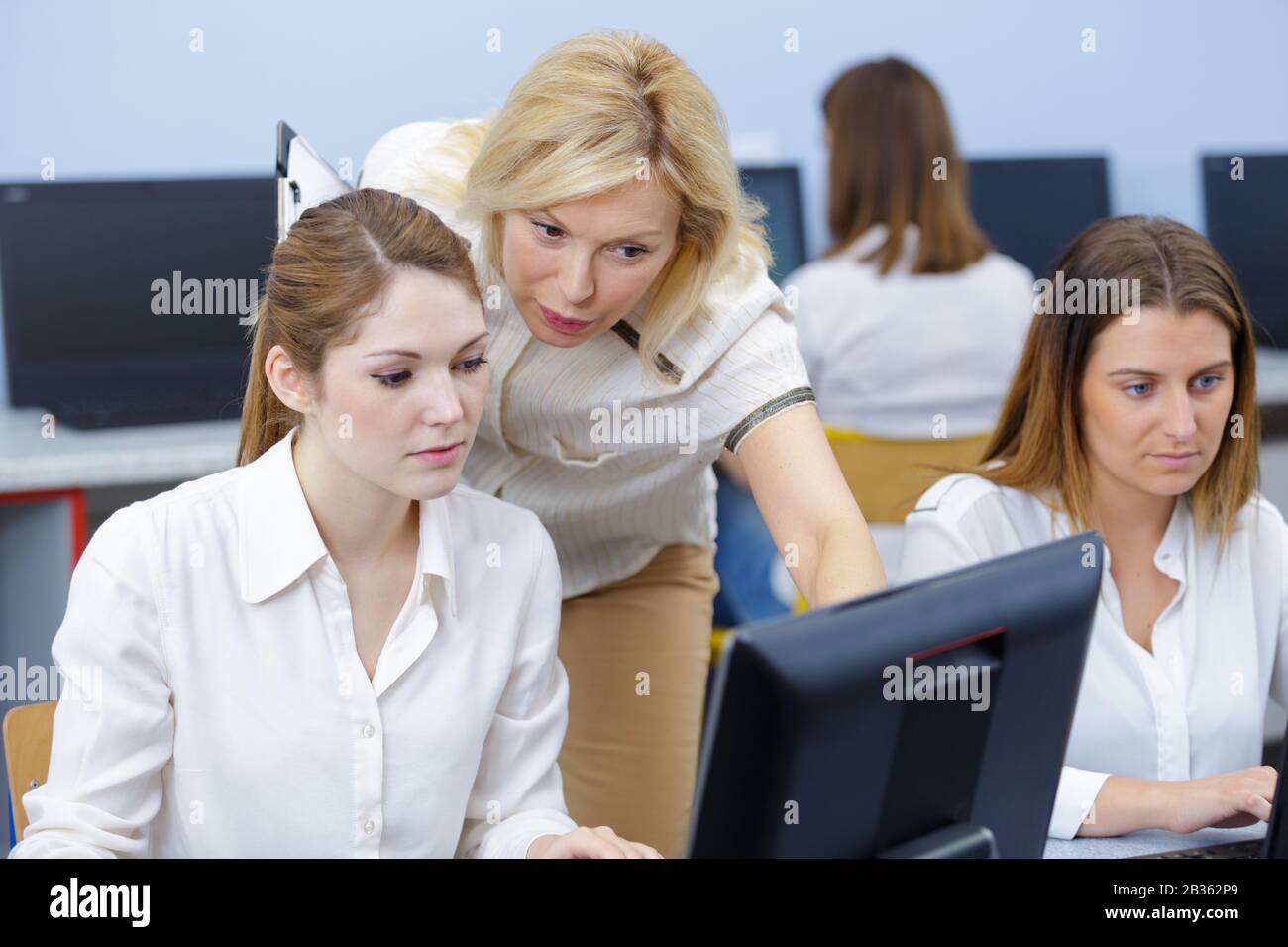 class of women in front of computer scree Stock Photo - Alamy