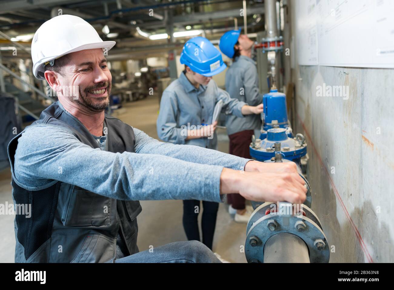 worker fixing industrial valve with Stock Photo - Alamy