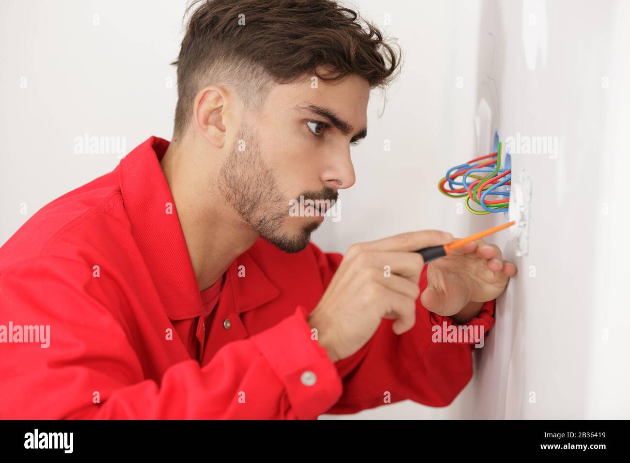 a man during repair of an electricity socket Stock Photo - Alamy
