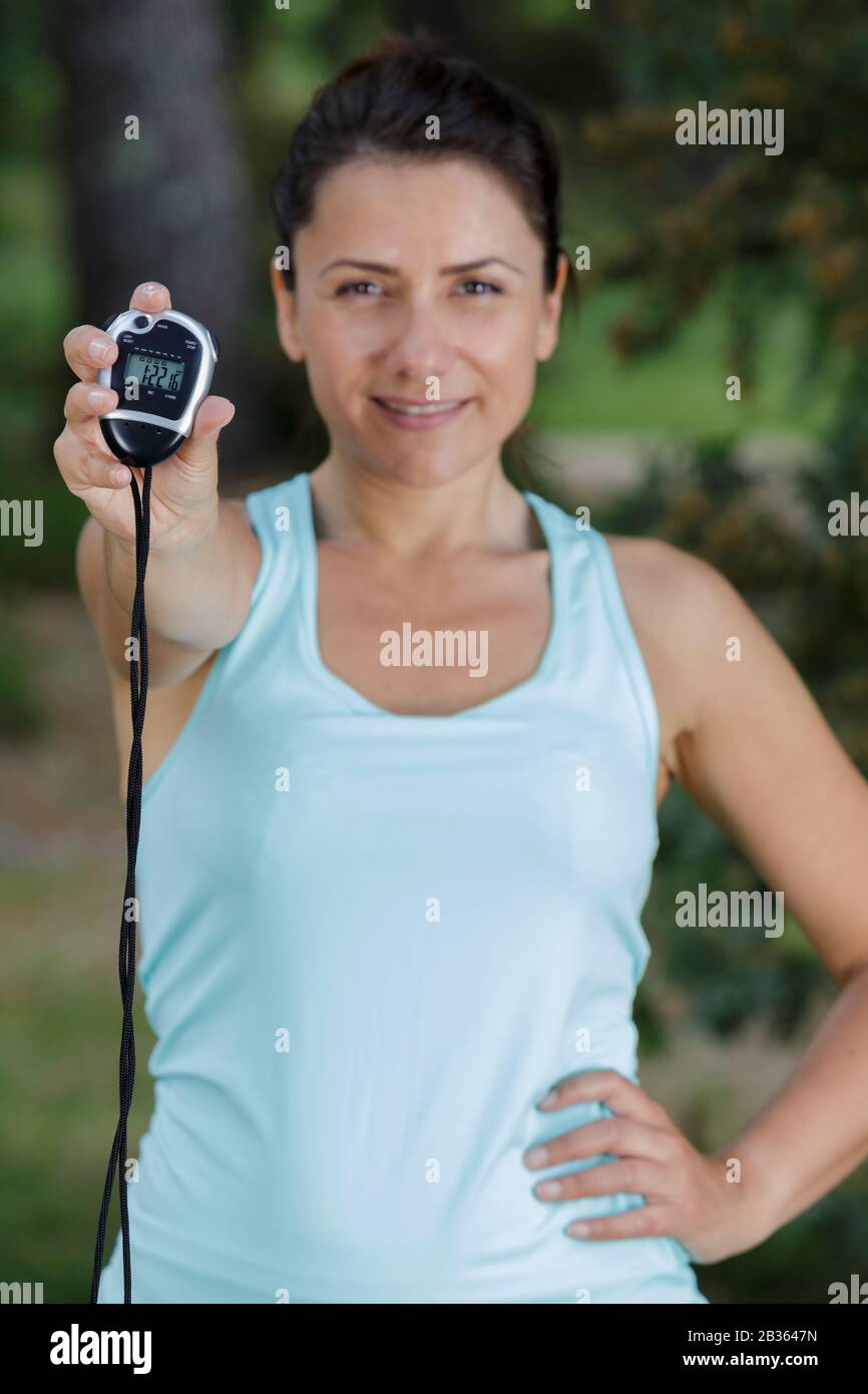 Woman with stopwatch hi-res stock photography and images - Alamy