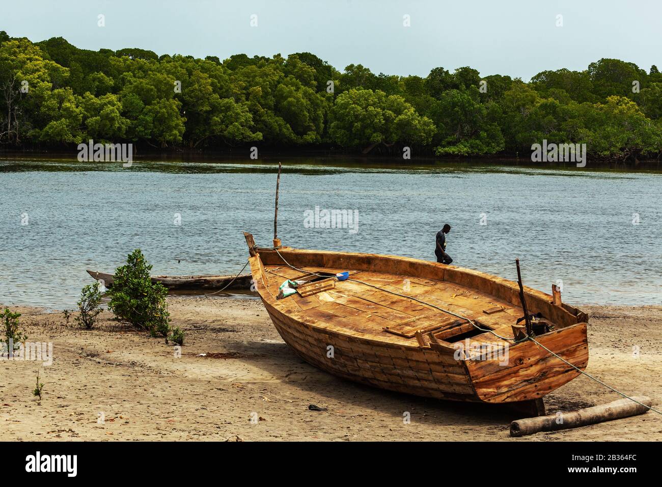 Fishing wooden boat on a beach near mangroves in Kenya Stock Photo - Alamy