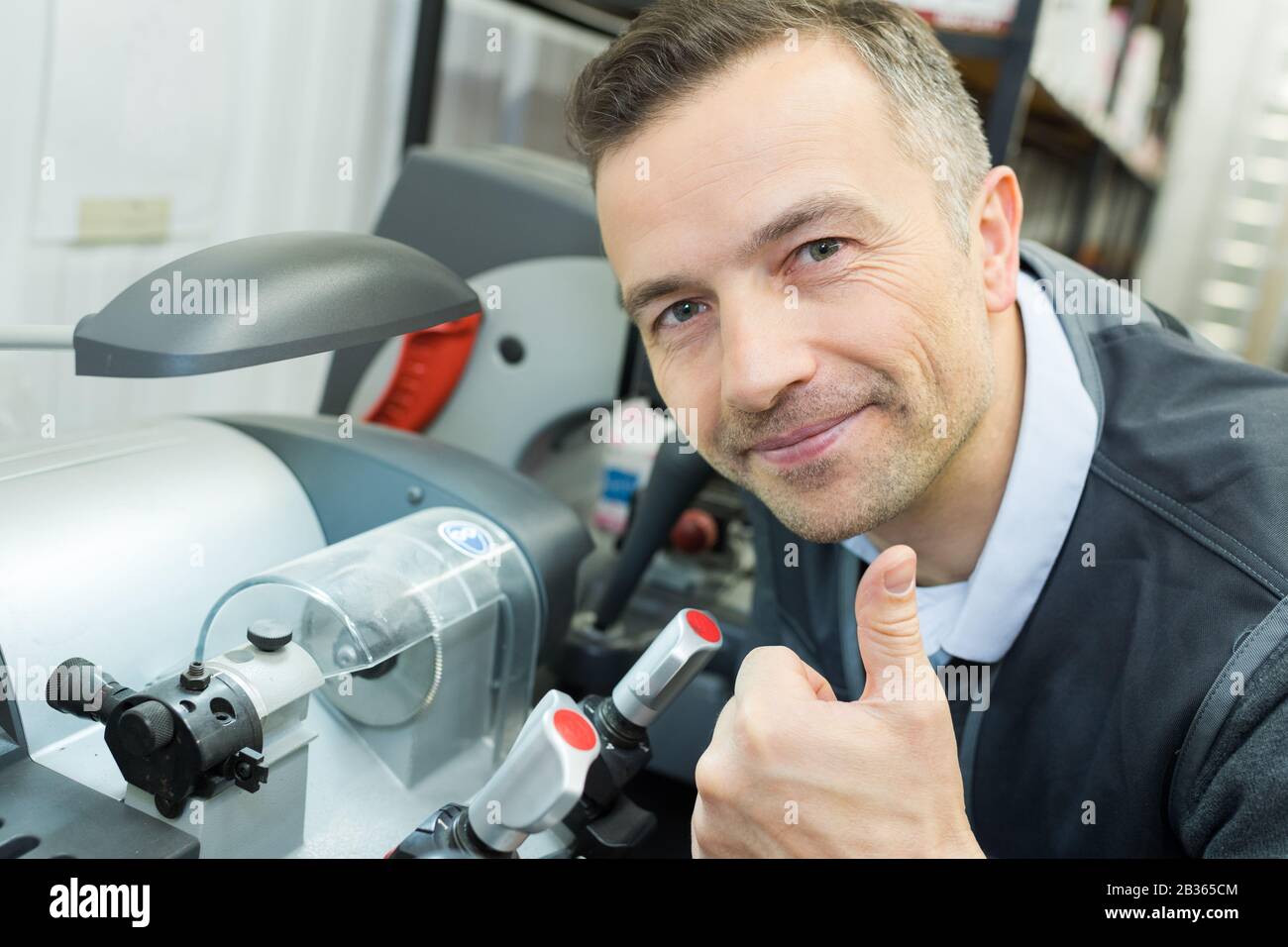 manufacturing engineer smiling showing thumbs up Stock Photo - Alamy