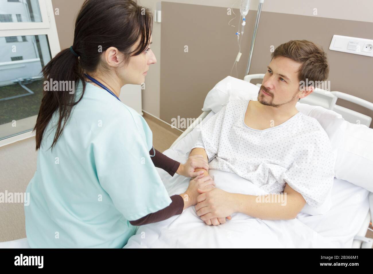 confident nurse with patient resting in hospital Stock Photo - Alamy