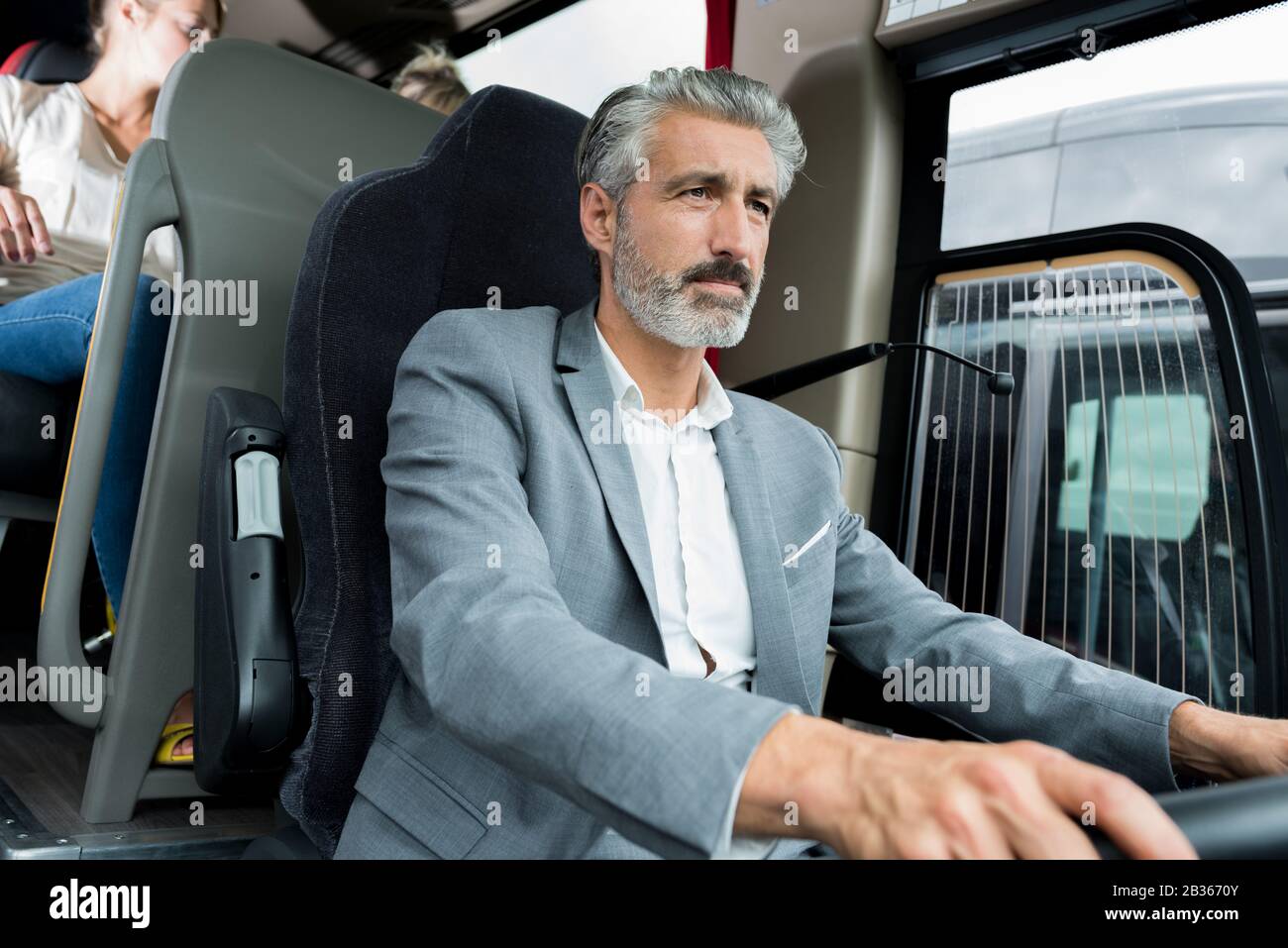a concentrated bus driver in a bus Stock Photo - Alamy