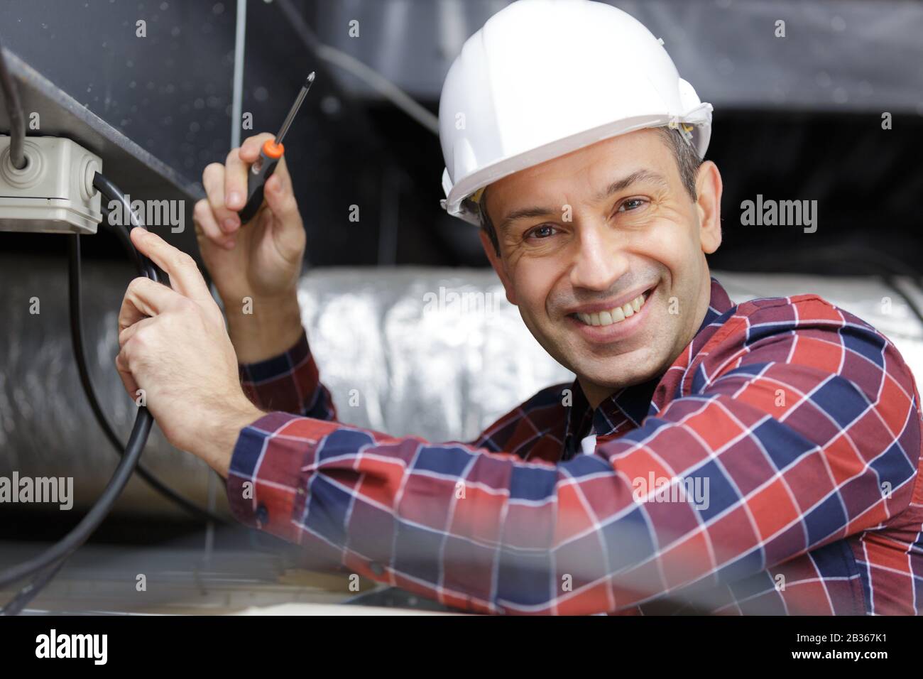 male engineer fixing solar pannels cables Stock Photo - Alamy