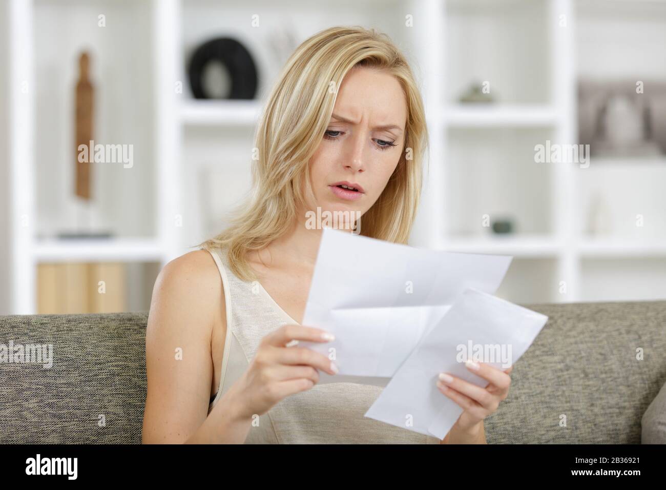sad woman complaining reading a letter Stock Photo - Alamy