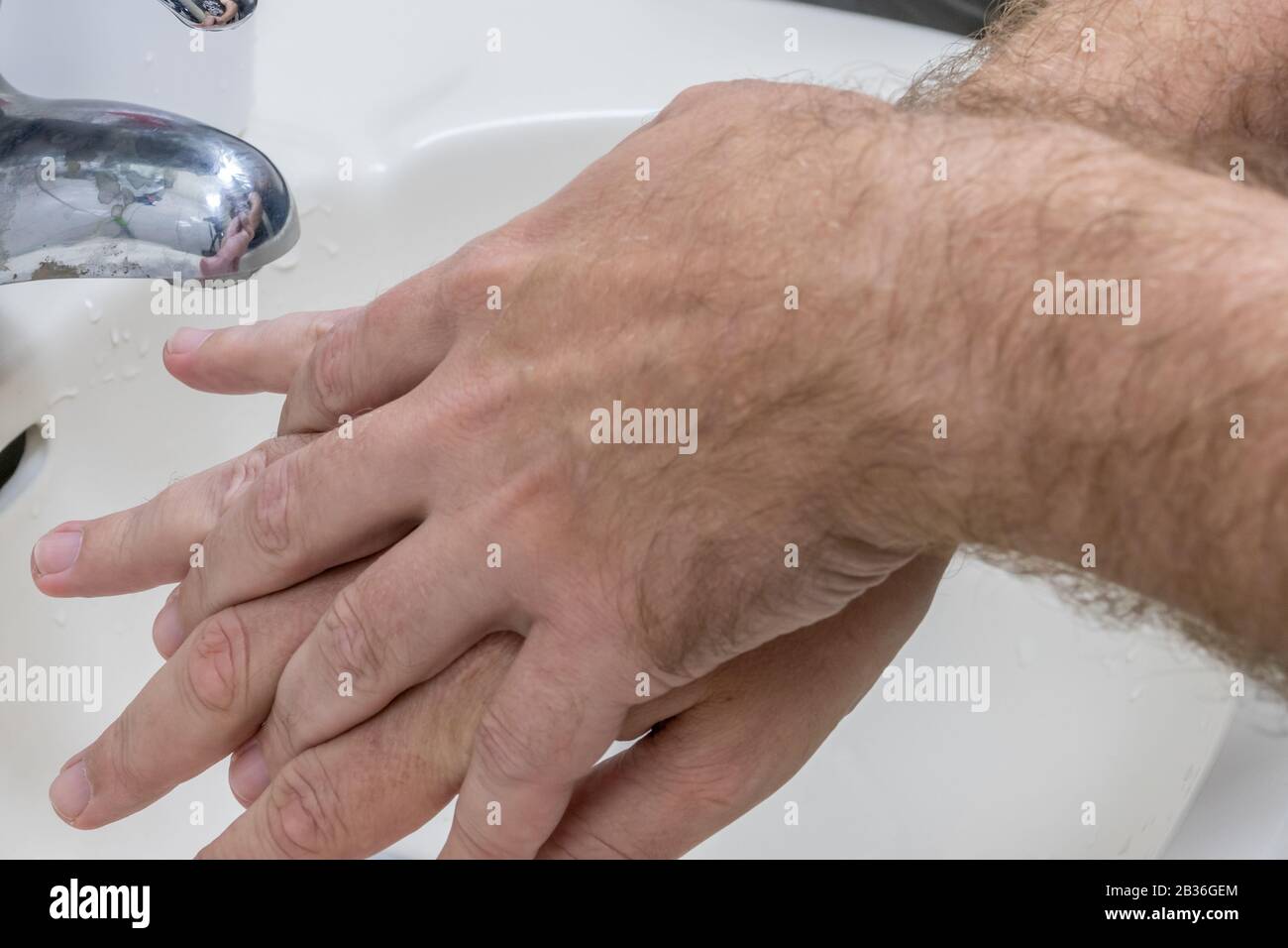 Man washing hands in basin close-up, one of several in handwashing ...