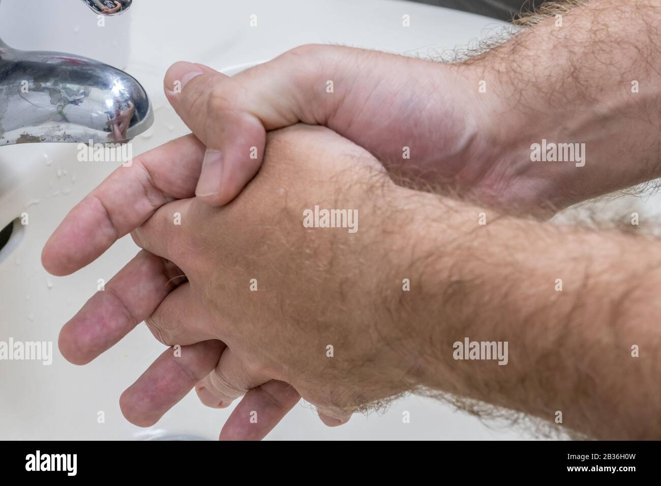 Man washing hands in basin close-up, one of several in handwashing ...