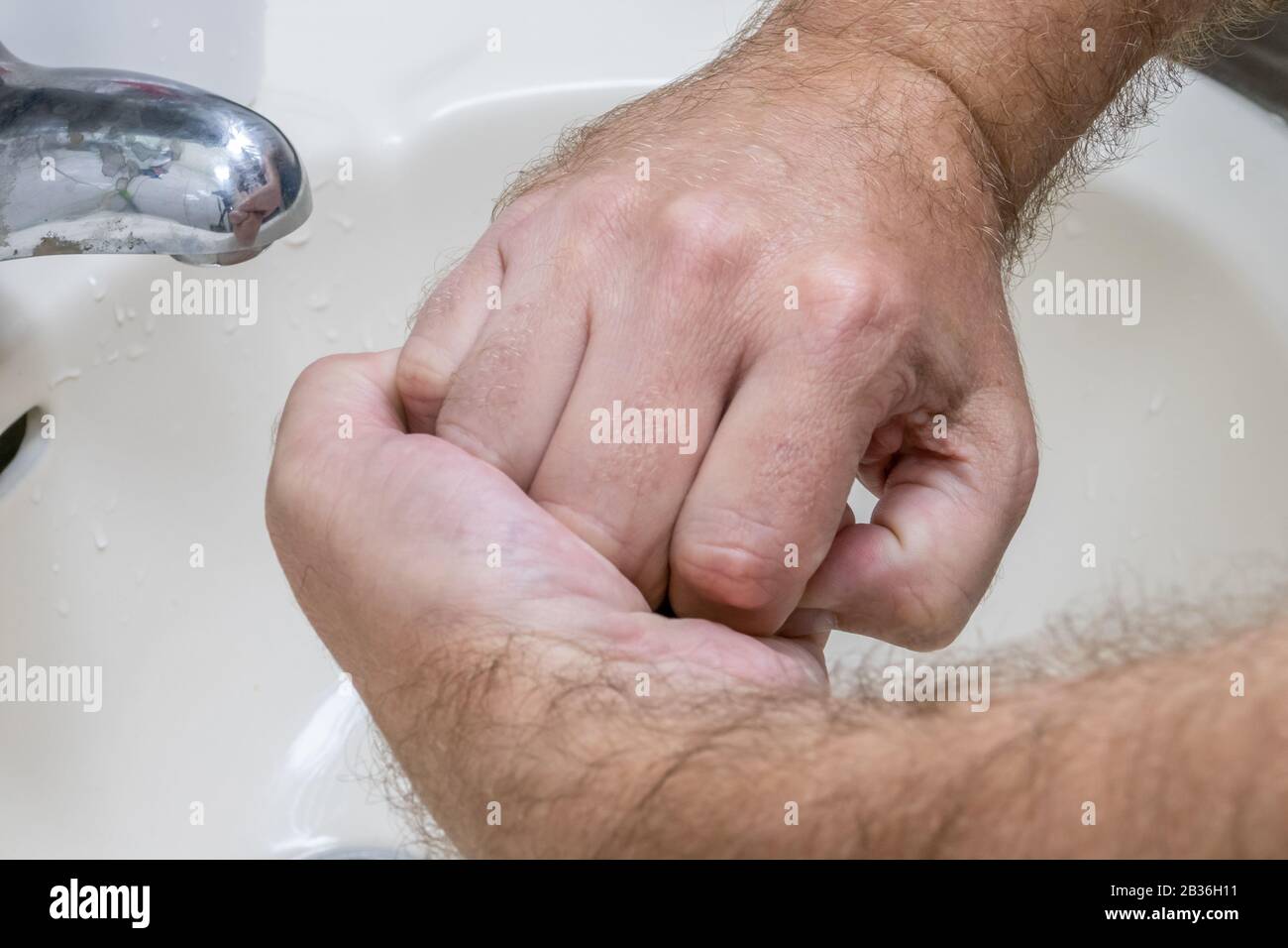 Man washing hands in basin close-up, one of several in handwashing ...