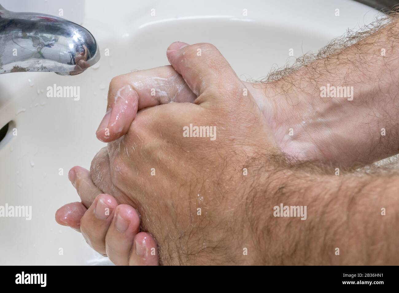 Man washing hands in basin close-up, one of several in handwashing ...