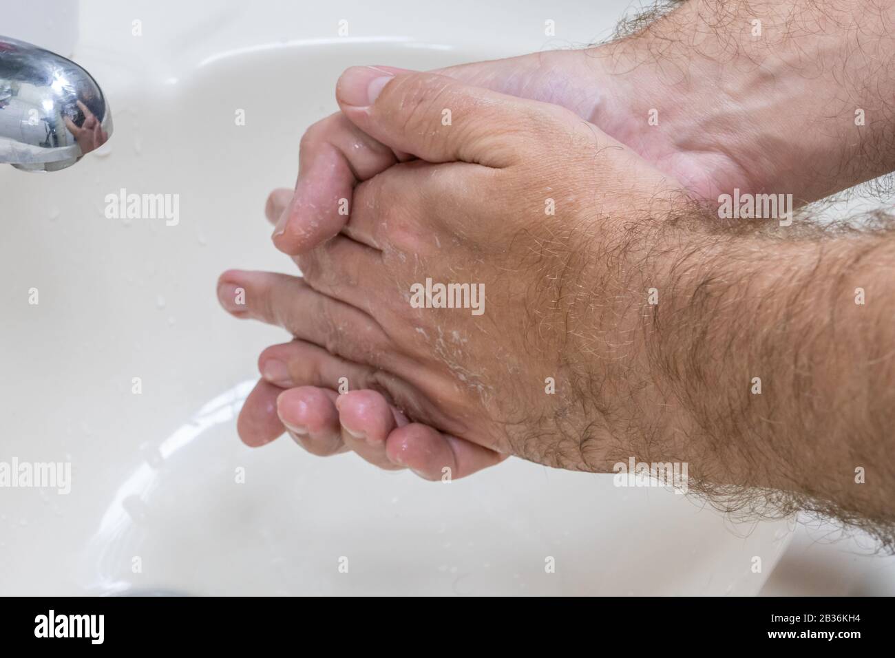 Man washing hands in basin close-up, one of several in handwashing ...