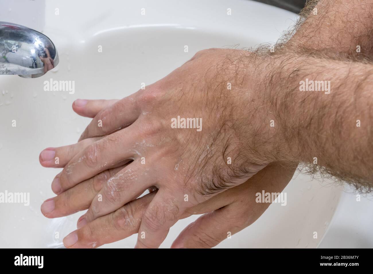 Man washing hands in basin close-up, one of several in handwashing ...