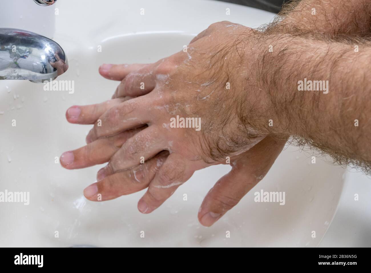Man washing hands in basin close-up, one of several in handwashing ...