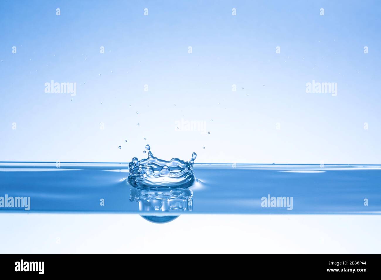 Drop splashing in water Stock Photo - Alamy
