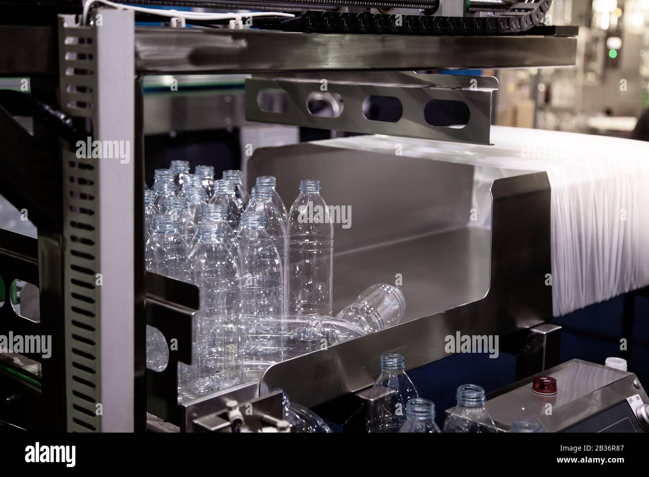 Production line collecting empty plastic bottle from blowing machine ...