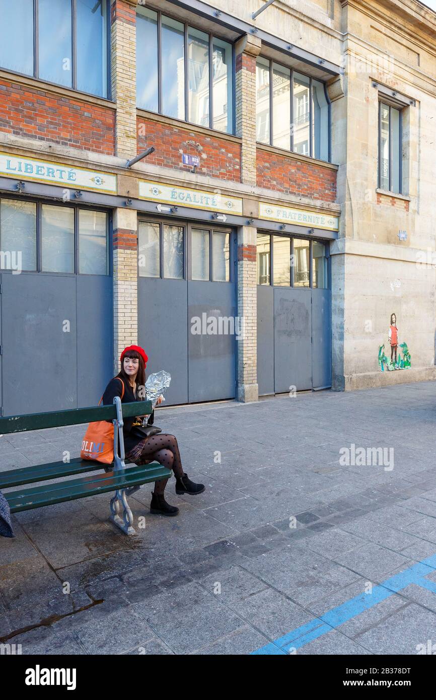 France, Paris, woman sitting on a bench in Parvis des 200 Enfants and ...