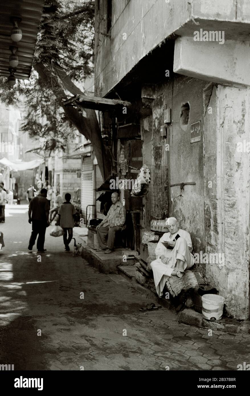 Travel Photography - Egyptian man reading in the alleyways of Islamic ...