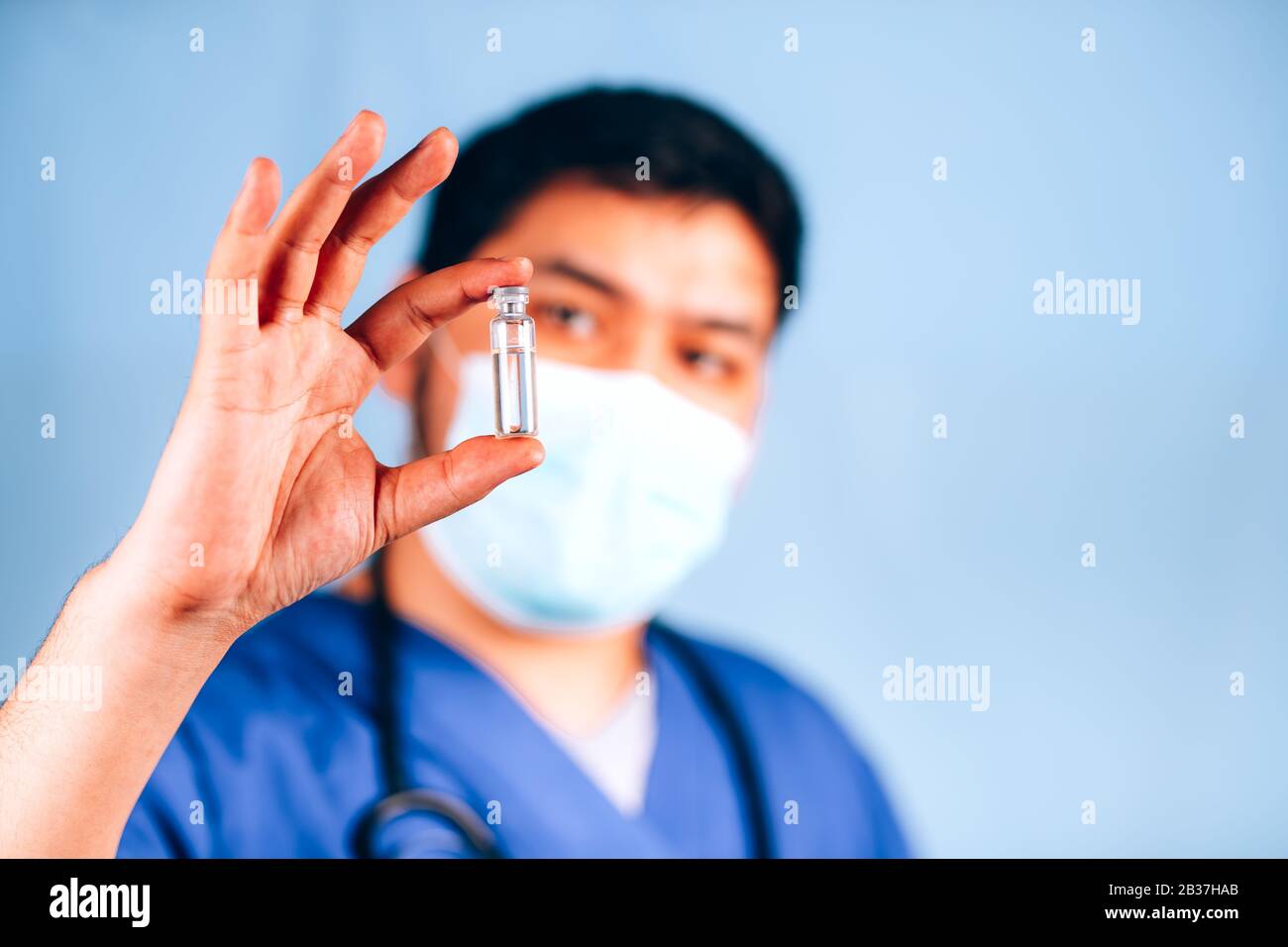 the doctor holds a test tube with medicine Stock Photo - Alamy