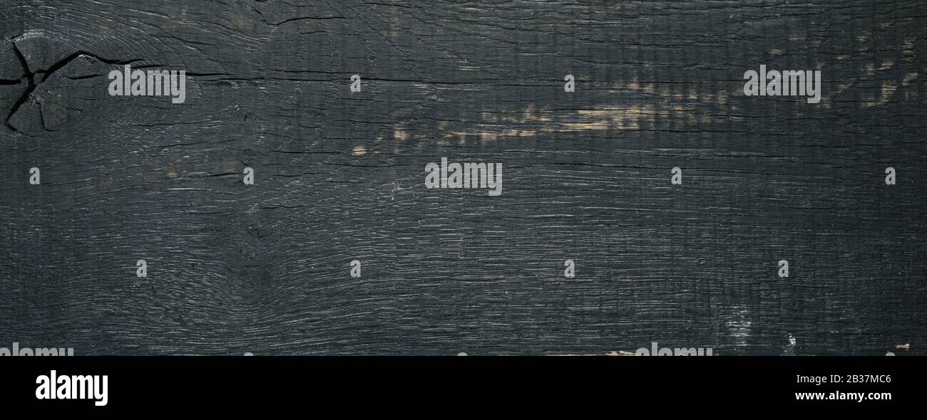 Old rustic dark oak plank using as natural background or header with ...