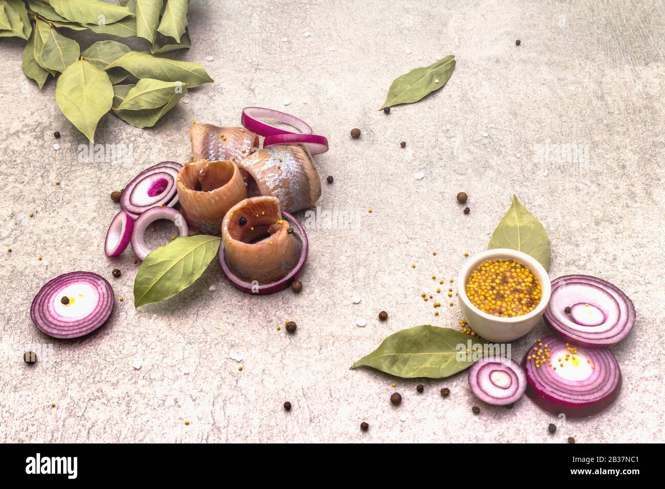 Rolled fillet of pickled Norwegian salted herring with spices and ...