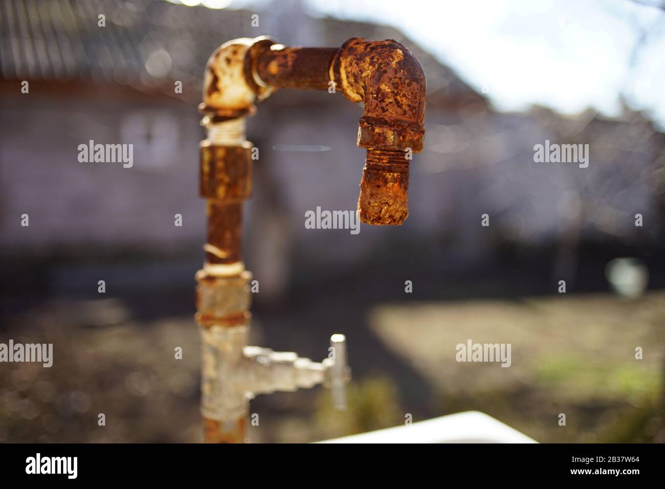 Old rusty water tap in a rural yard Stock Photo - Alamy