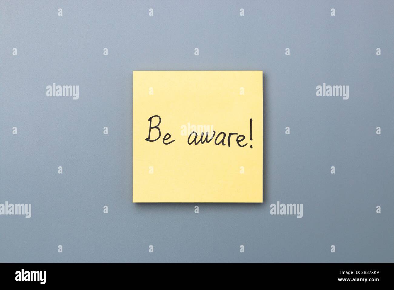be aware on yellow sticky note over a grey background. april fools day ...