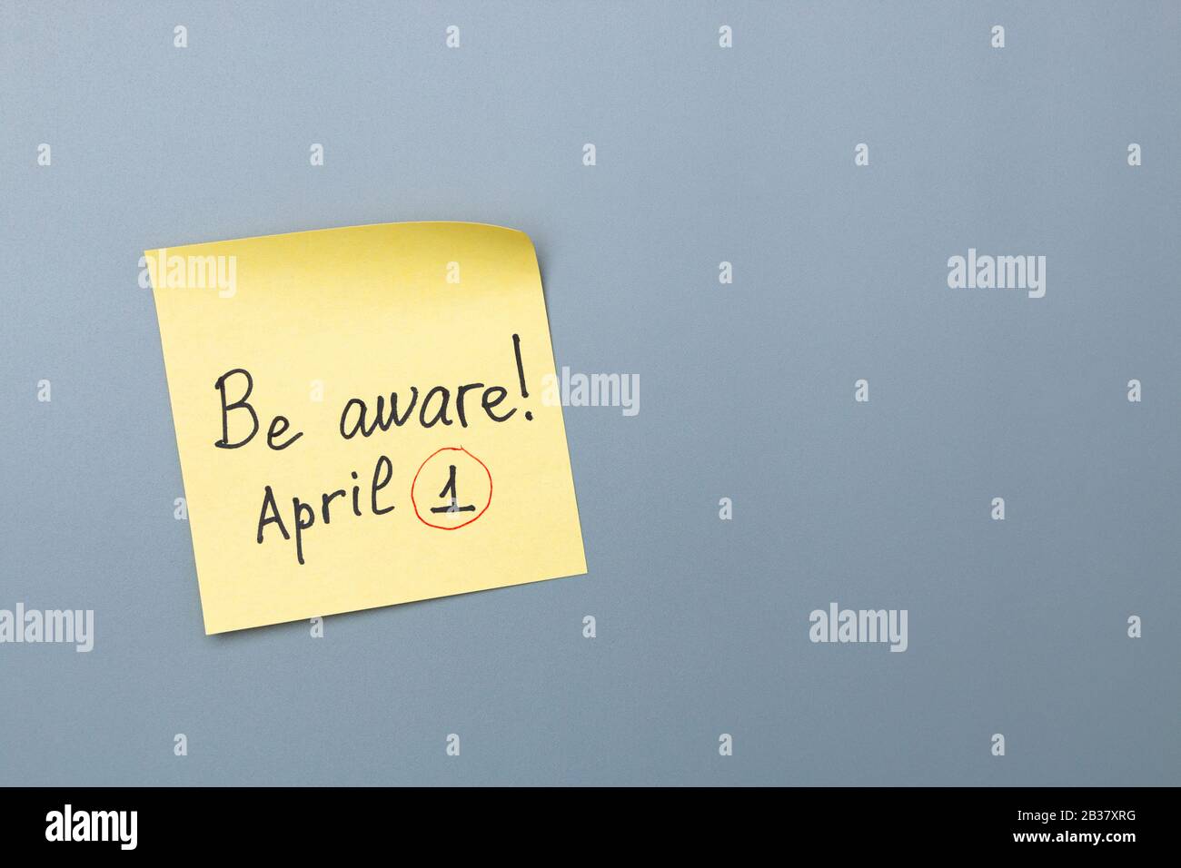 april fools day reminder on yellow sticky note. be aware and do not let ...