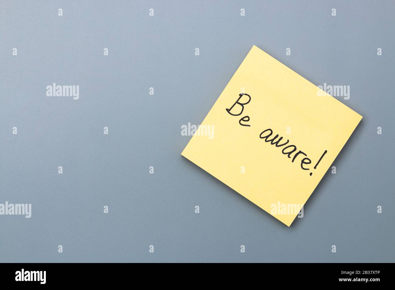 be aware on yellow sticky note over a grey background. april fools day ...