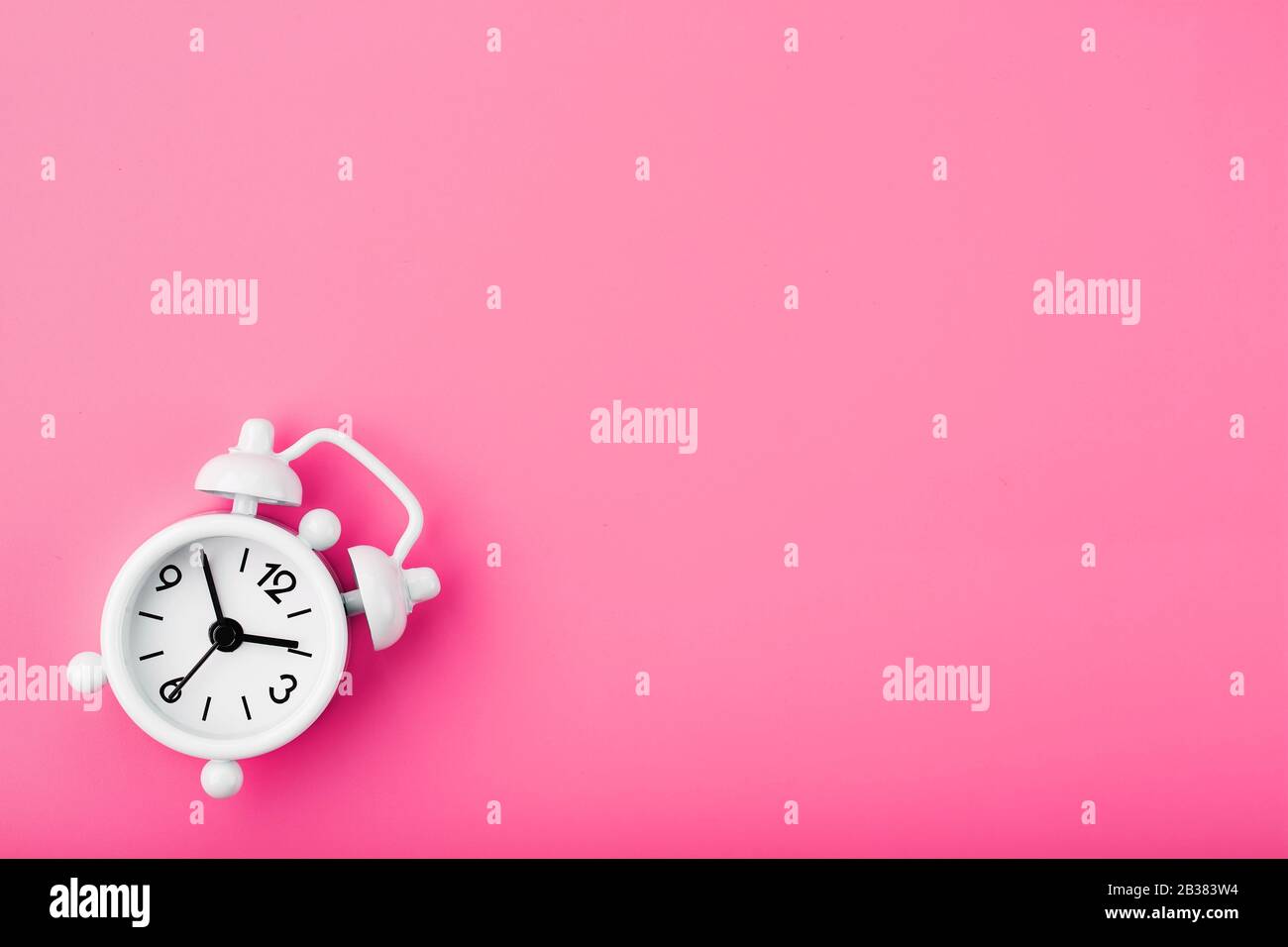 White retro alarm clock on pink background. Concept of time with free ...