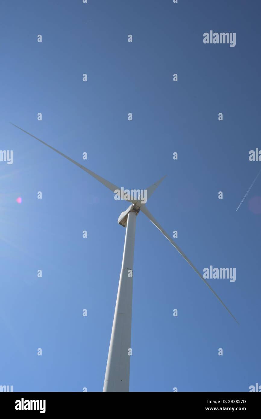 Wind turbine moving blades with blue sky Stock Photo - Alamy