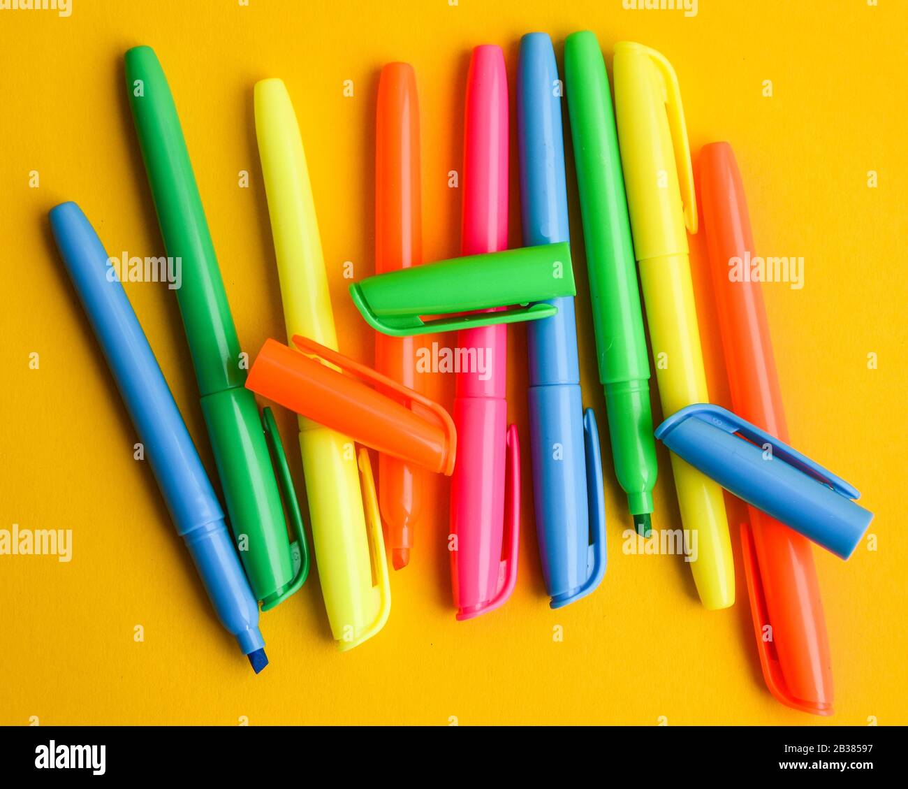 Felt-tip pens on a yellow background with copy space, set of new bright ...