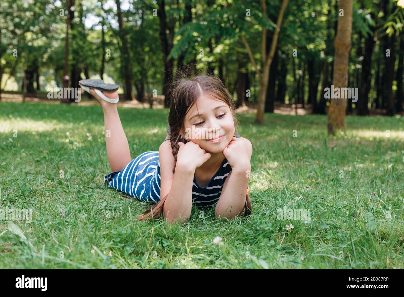 Child kid portrait lying grass spring hi-res stock photography and ...