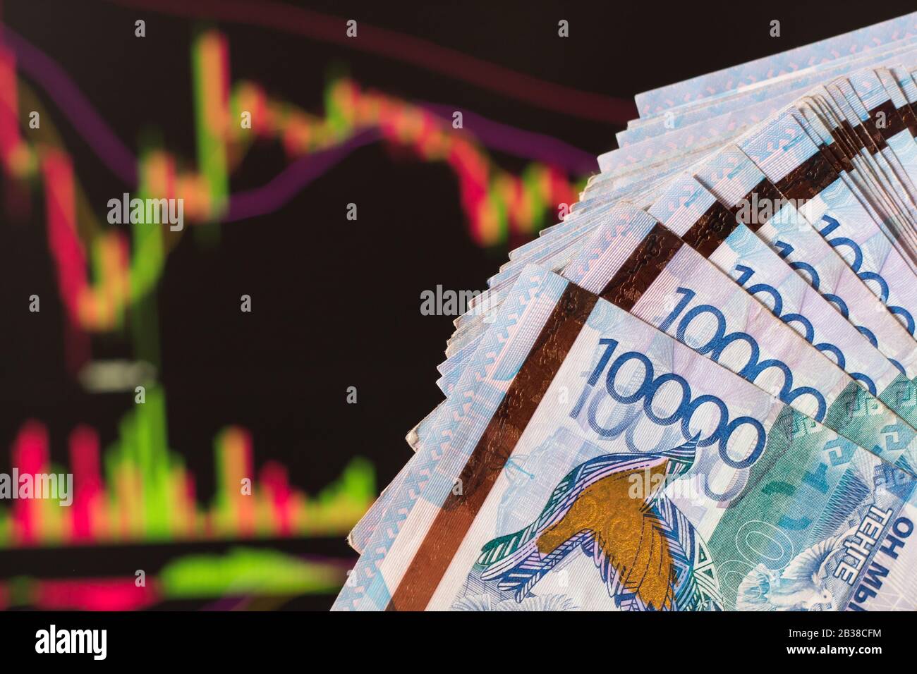 Tenge in Kazakhstan against the background of a laptop with an open ...