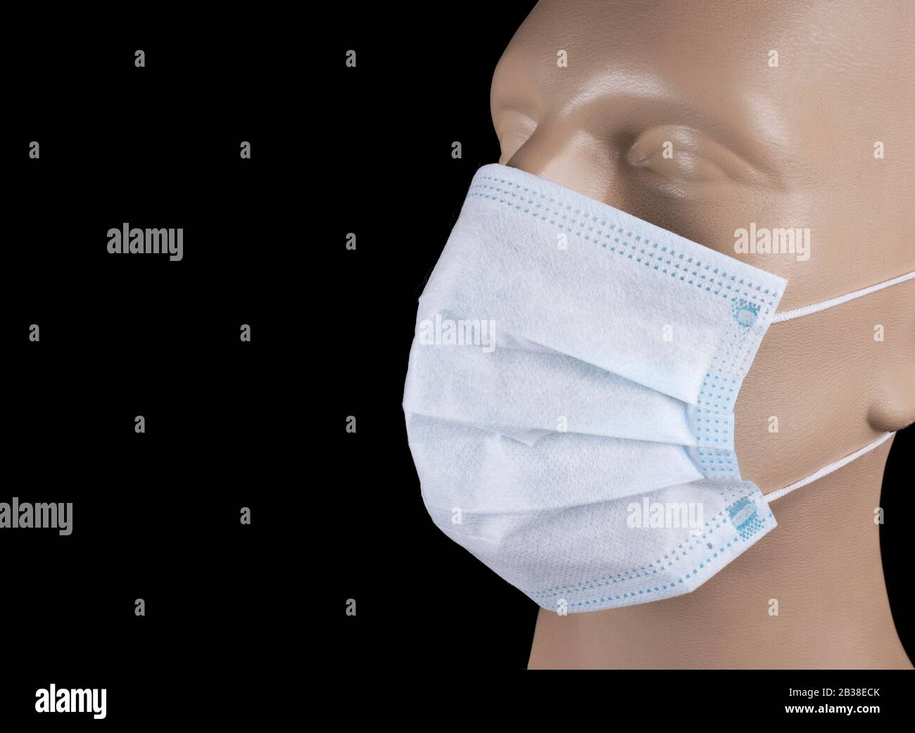 Mannequin in medical face mask on black background Stock Photo - Alamy