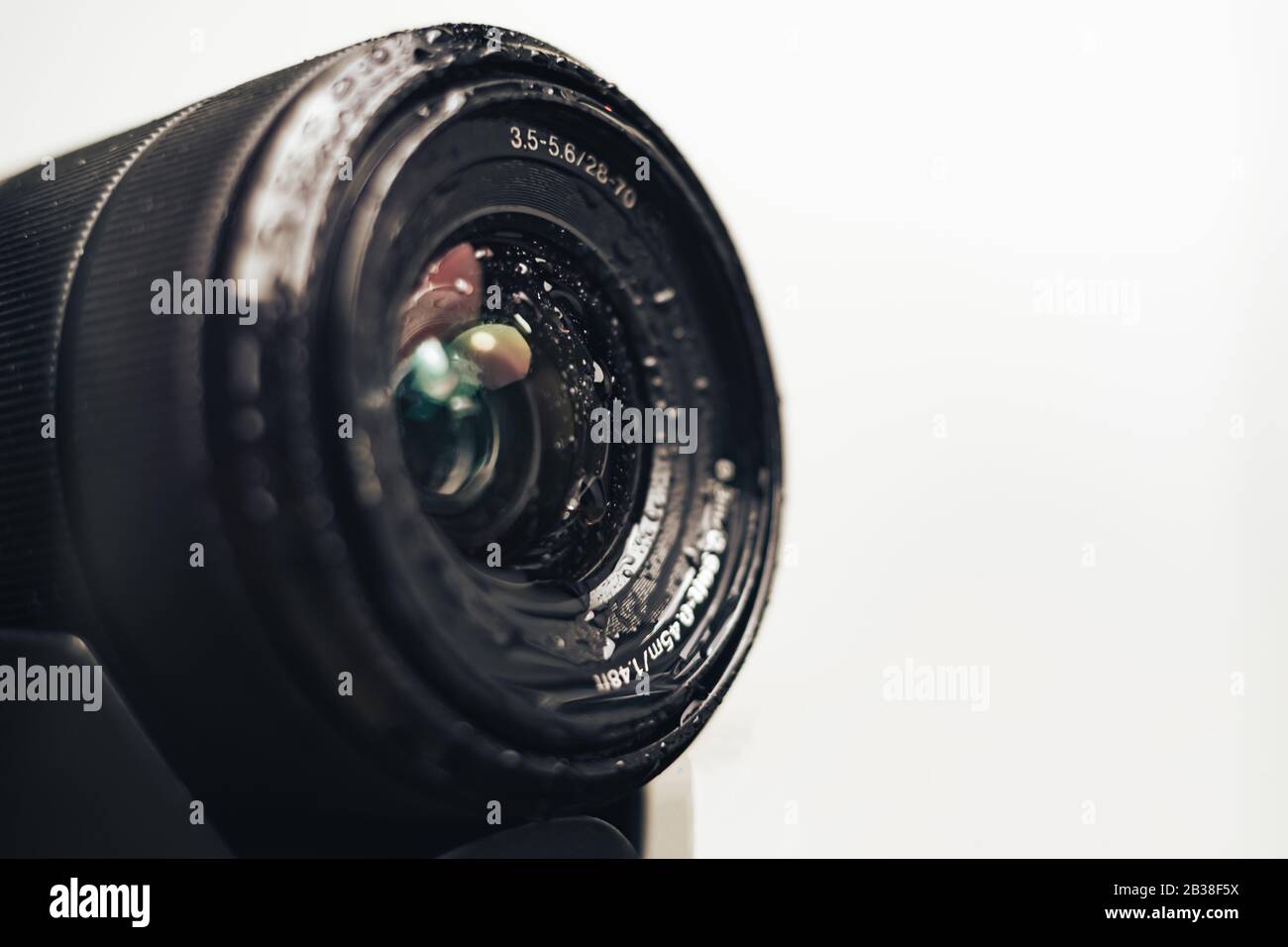 Close up beautiful Camera lens of drop water, on a white Background ...