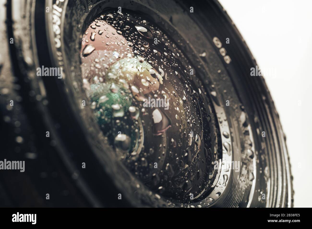 Close up beautiful Camera lens of drop water, on a white Background ...