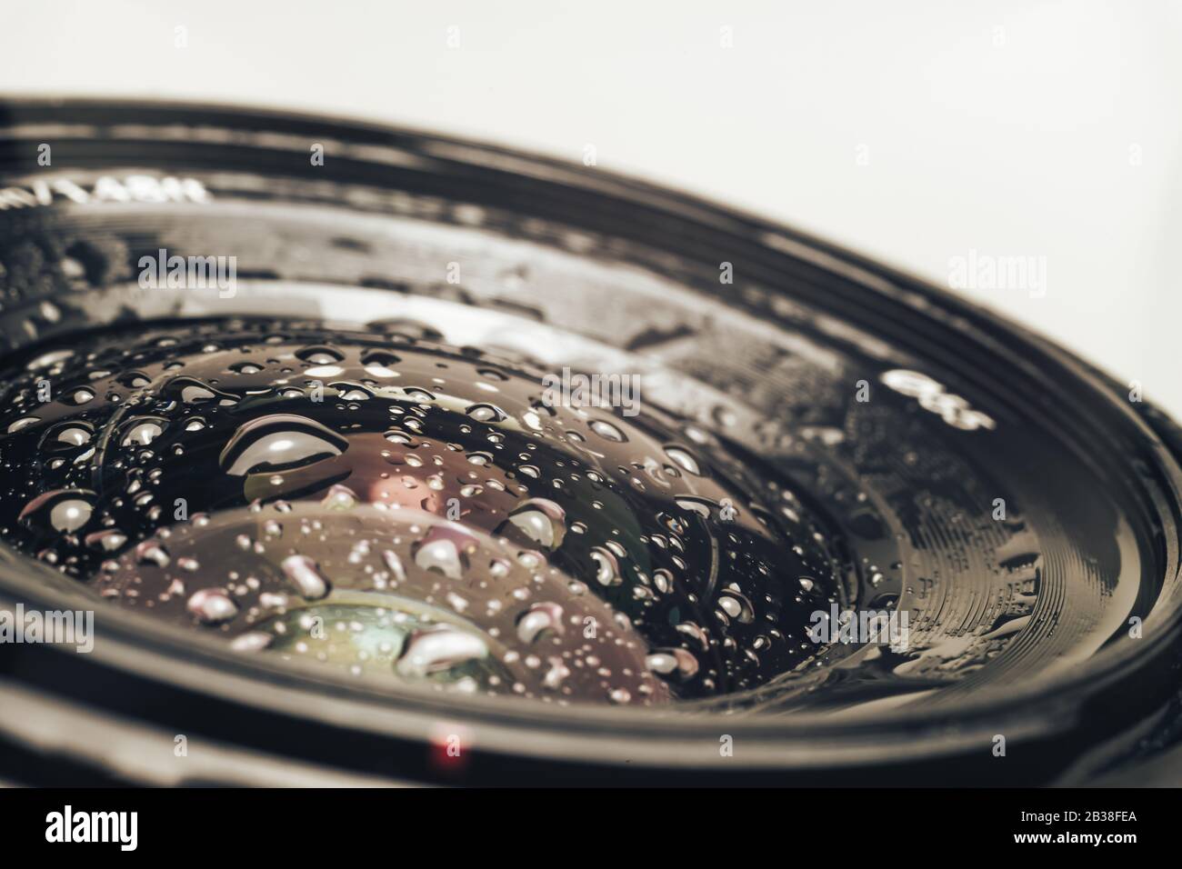 Close up beautiful Camera lens of drop water, on a white Background ...