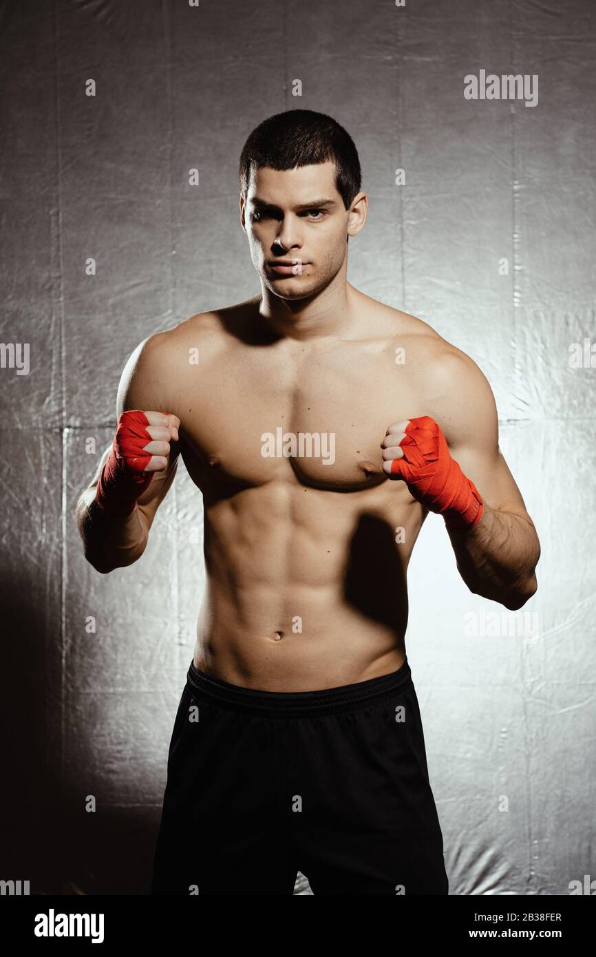 Boxing male portrait standing in a rack on silver background with red ...