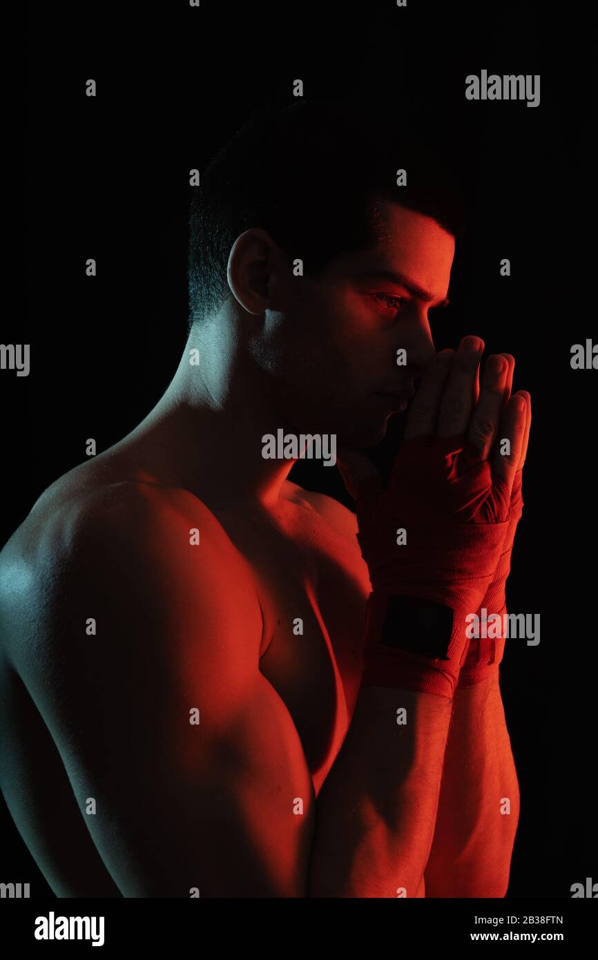 Fighter close up portrait before fight, over black background in red ...