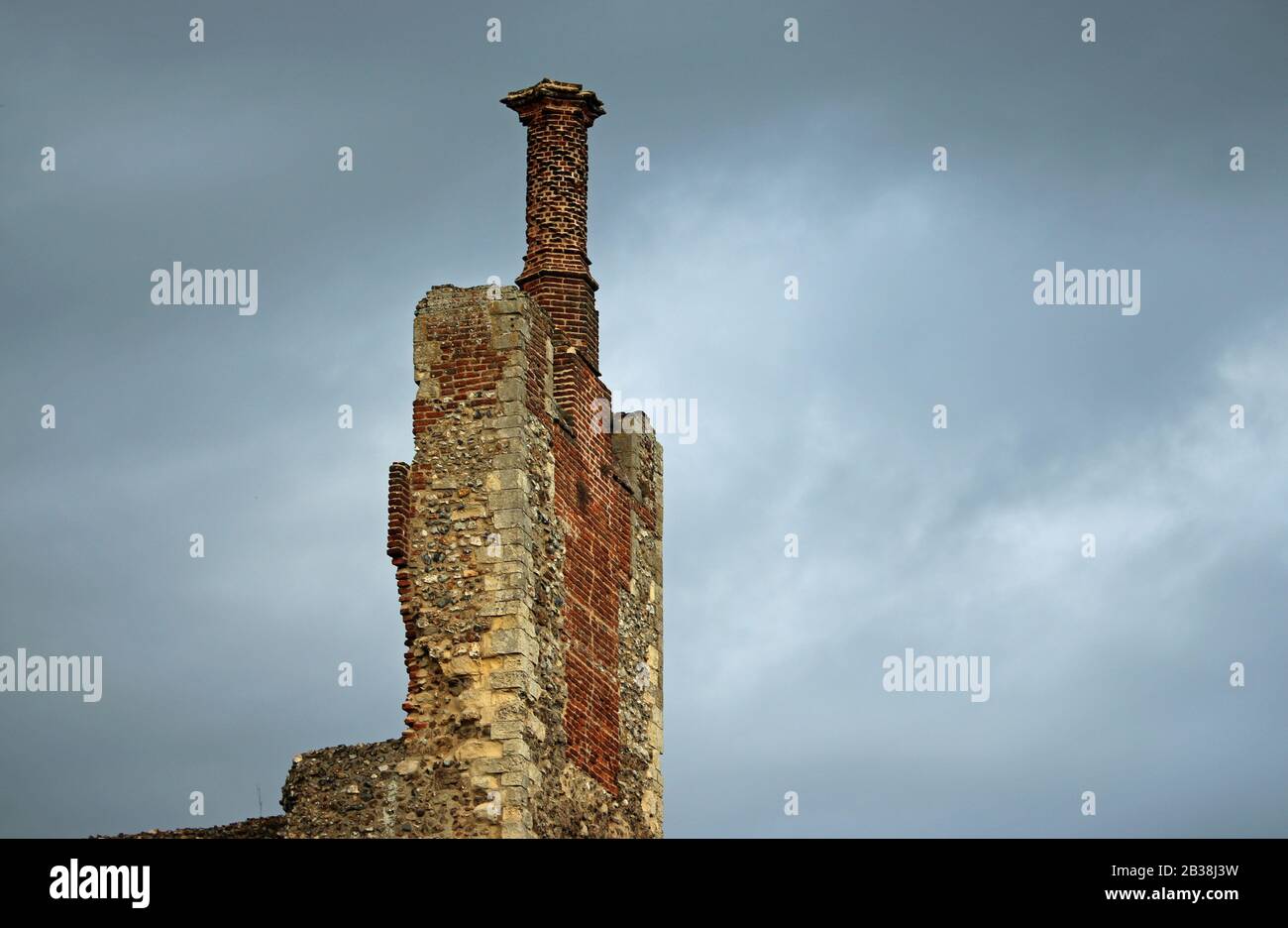 Tudor twisted barley sugar chimney pot on chimney stack with flint, red ...