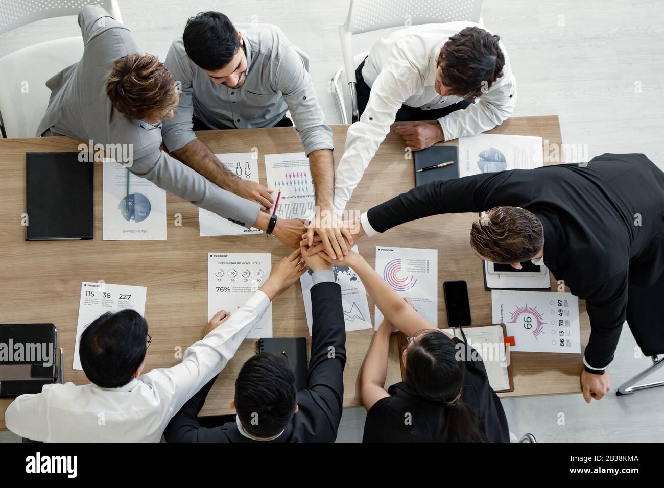 Top view join hands on work table of team of Asian people and ...