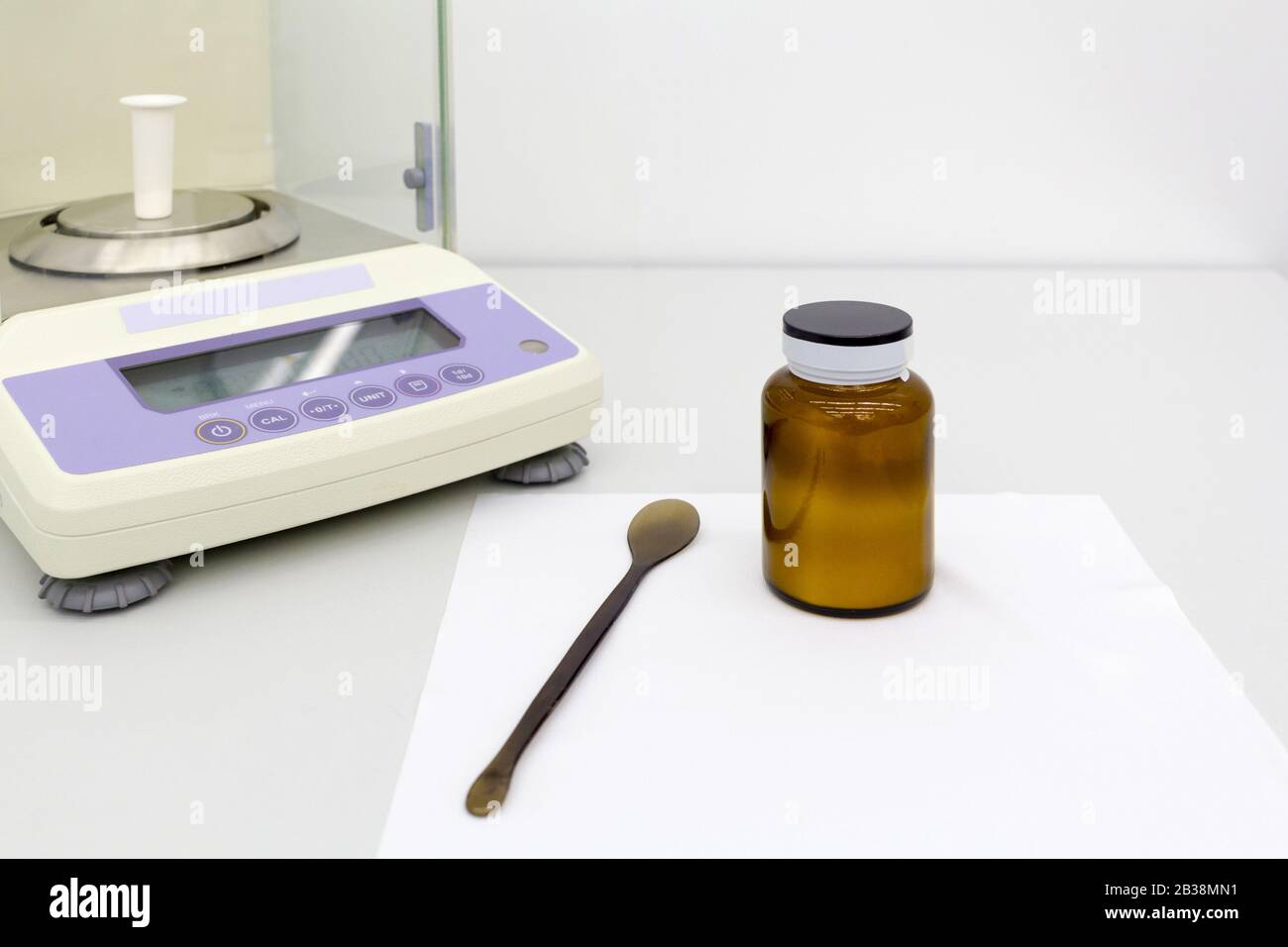 laboratory scale on table with materials in bottles Stock Photo - Alamy