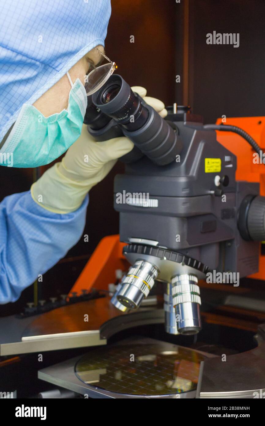 The inspector making incoming check the Silicon Wafers with chips on ...